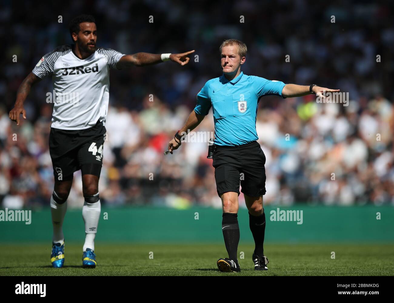 Match referee Gavin Ward points to penalty spot with Derby County's Tom ...