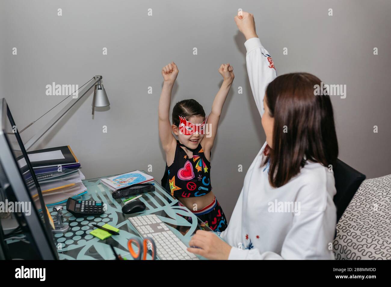 Woman teleworking and playing with her daughter Stock Photo - Alamy