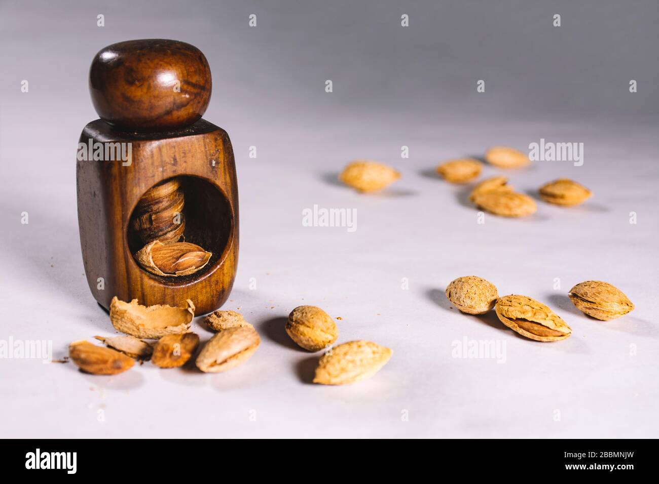 A nutcracker with open and closed almonds isolated on white background ...