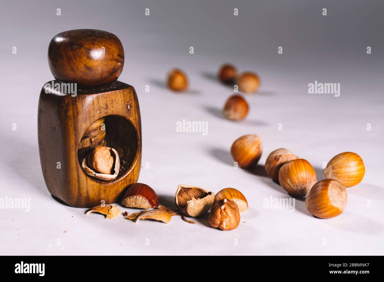 A nutcracker with open and closed hazelnuts isolated on white ...
