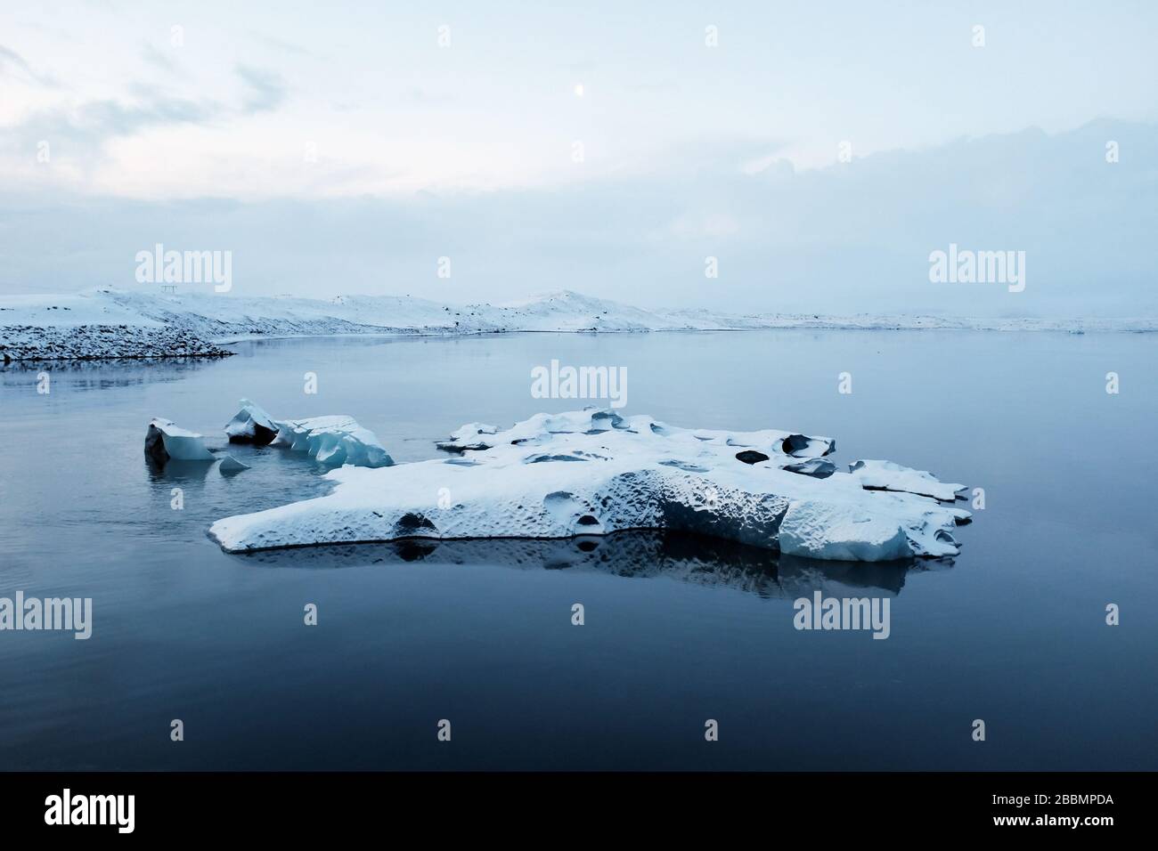 A small iceberg floats out to sea calved from an inland glacier Stock ...