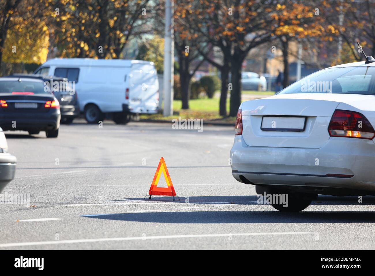 There is yellow triangle accident sign on road Stock Photo - Alamy