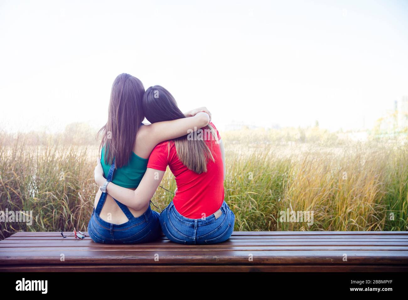 Two best female friends embracing together while sitting outdoors Stock ...