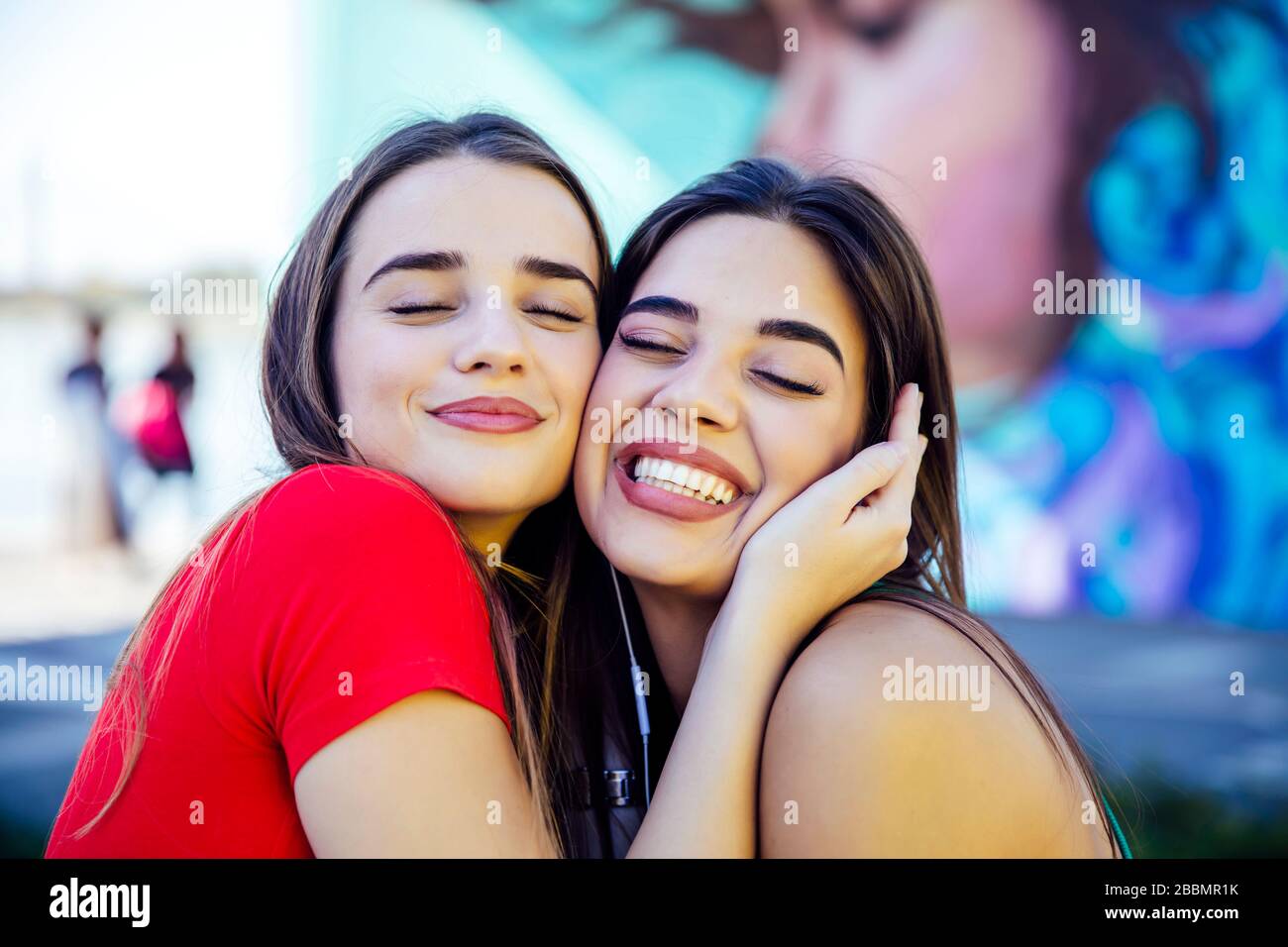 Two best female friends embracing together outdoors Stock Photo - Alamy