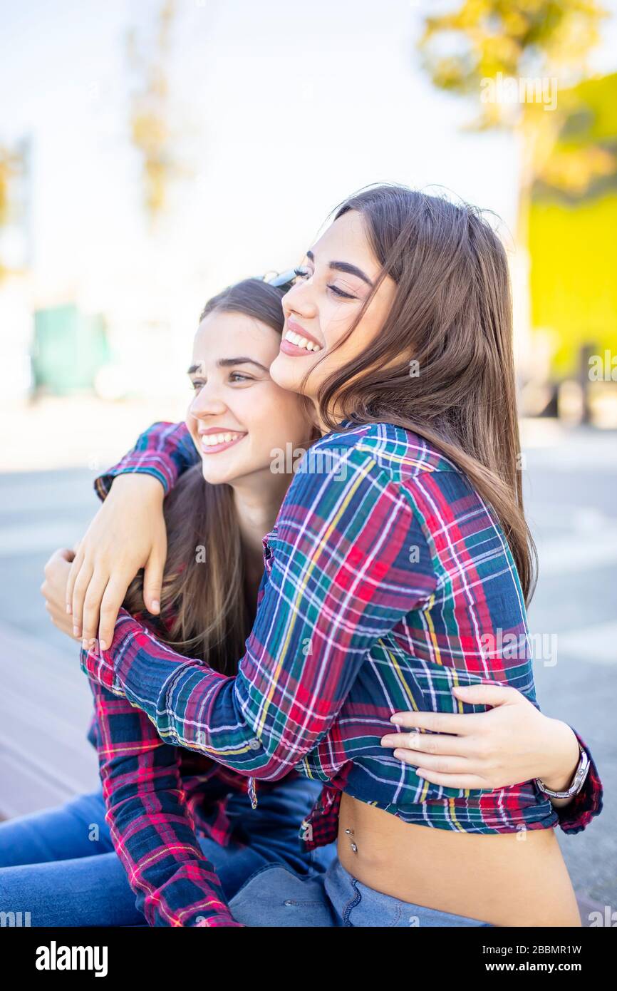 Two best female friends embracing together outdoors Stock Photo - Alamy