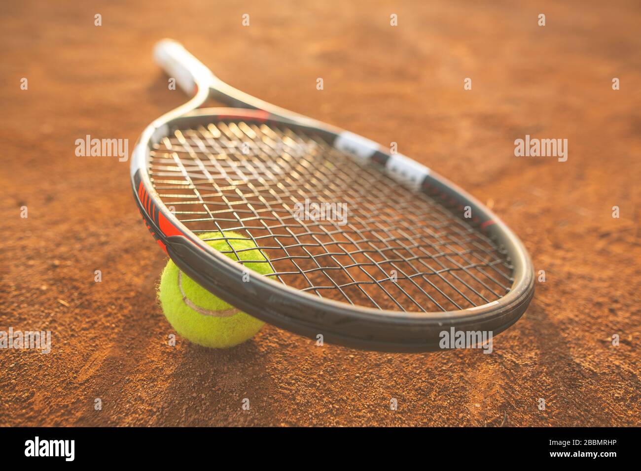 Close up of tennis racket with a ball on the tennis clay, sport concept ...