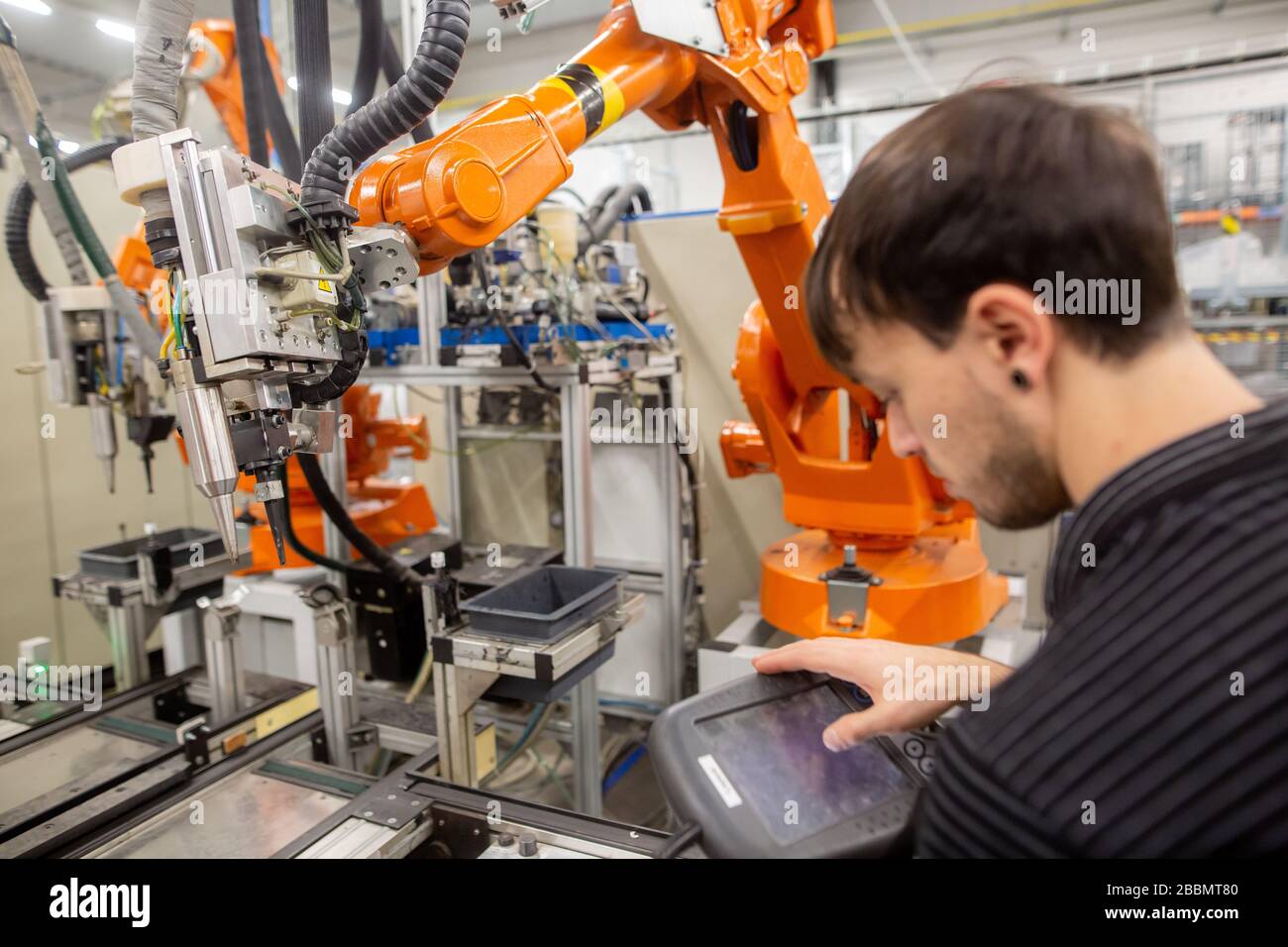 Man Programming Robot In Automotive Industrial Professional Programmer Industry Concept Stock