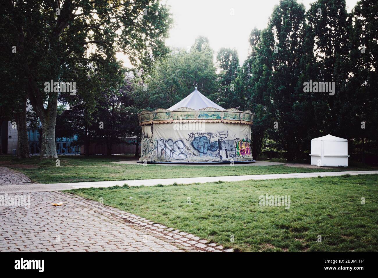 A merry-go-round, closed, in an abandoned park in Paris, with no one in ...