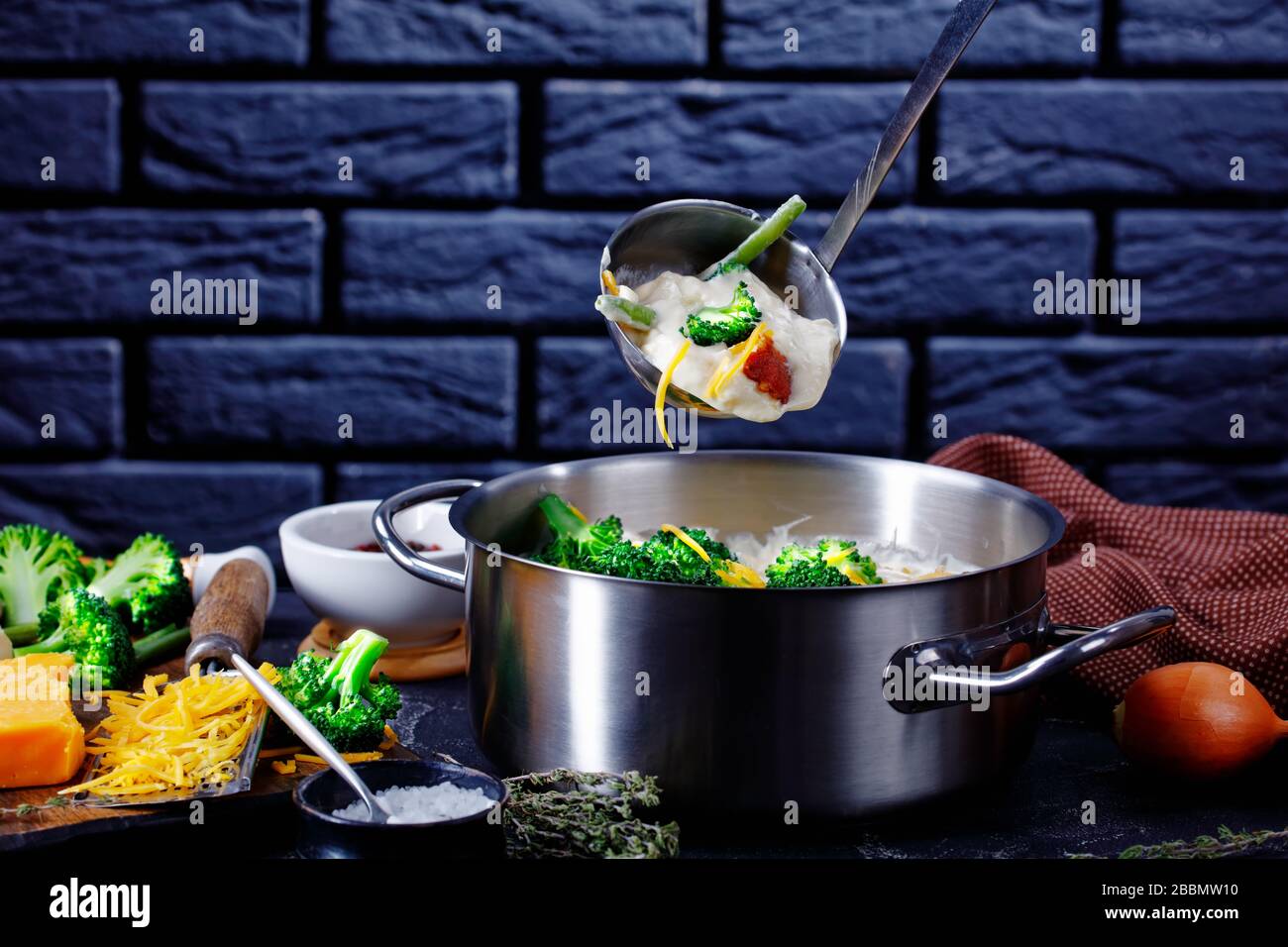 portion of cream soup with broccoli, green bean, fried bacon, and ...