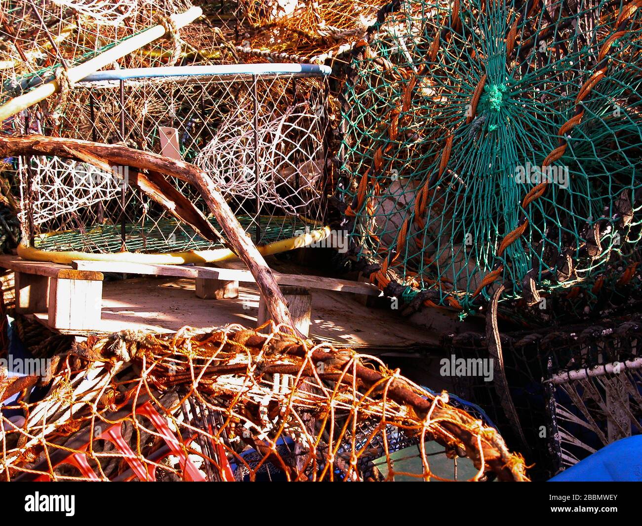 Brightly-coloured fishing nets and lobster and crab pots drying in the ...