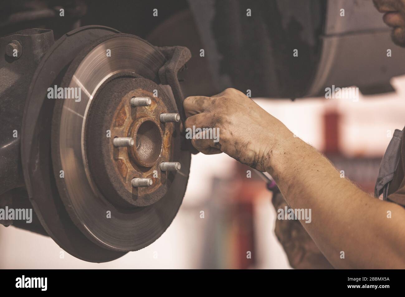Professional car mechanic changing car wheels, tires on the car ...