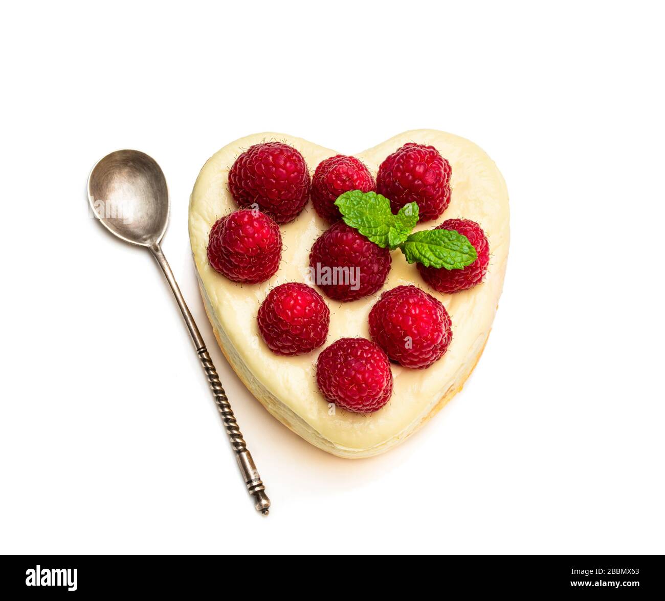 Heart shaped cheesecake with raspberry isolated on white. Top view ...