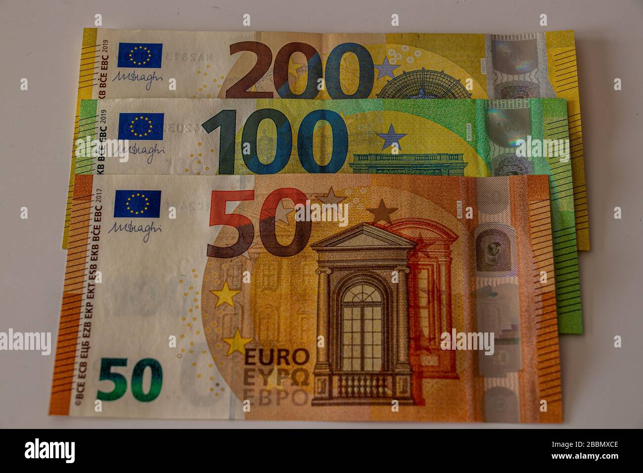 200, 100, 50 euro bill on table Stock Photo - Alamy