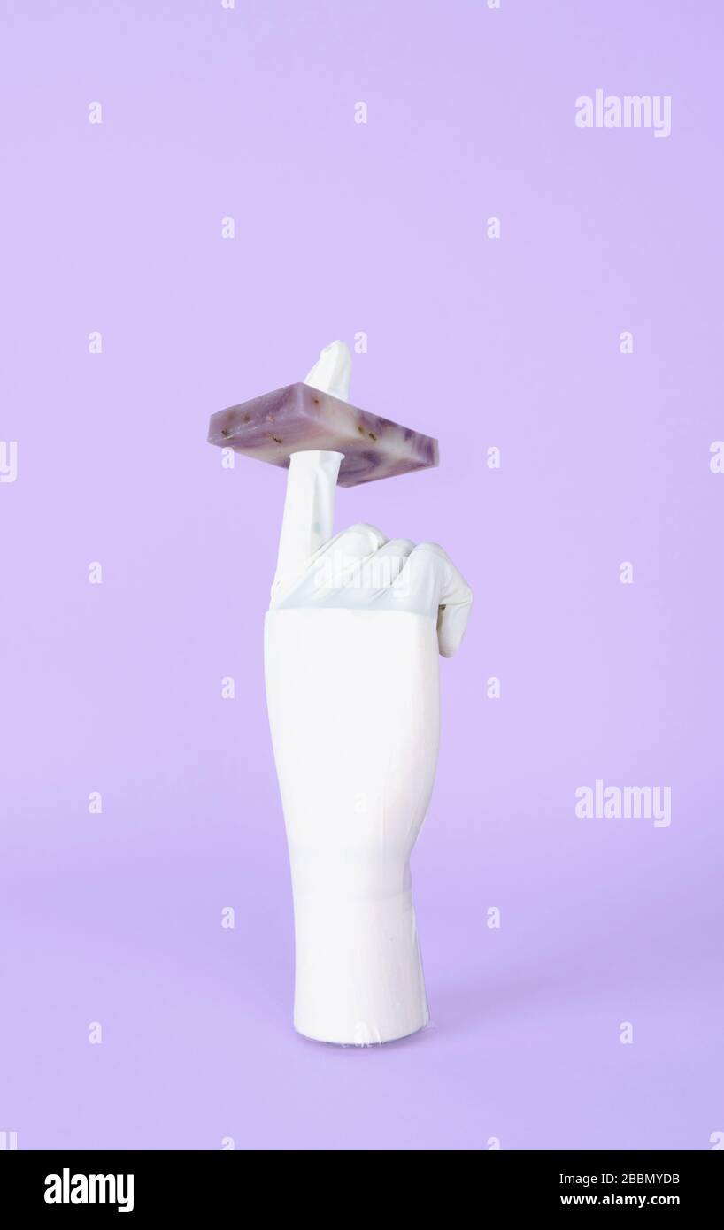 Gloved hand playing with levitating soap bars. Cleaning Hands Concept ...