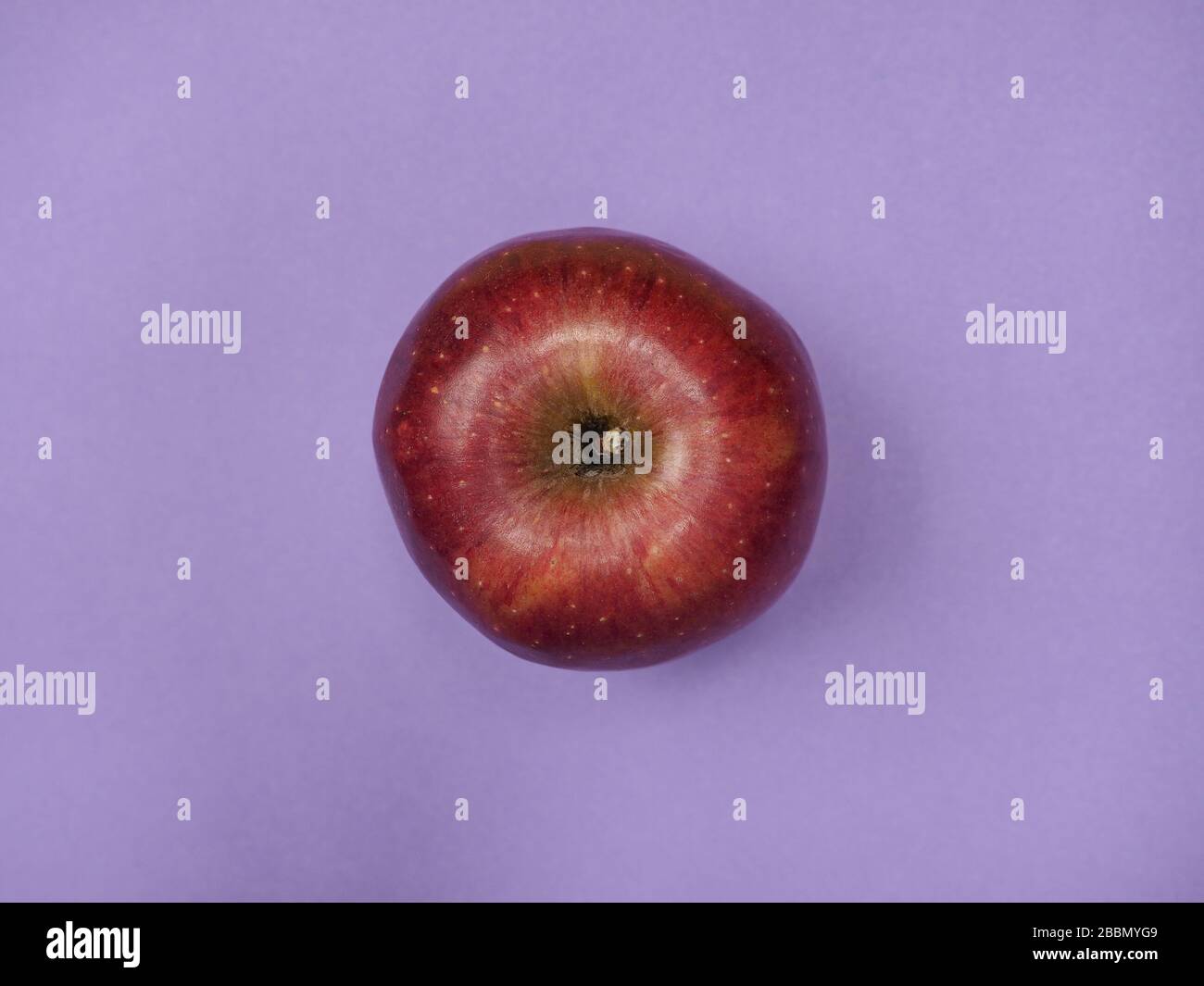 Top view of isolated red apple on plain purple background Stock Photo ...