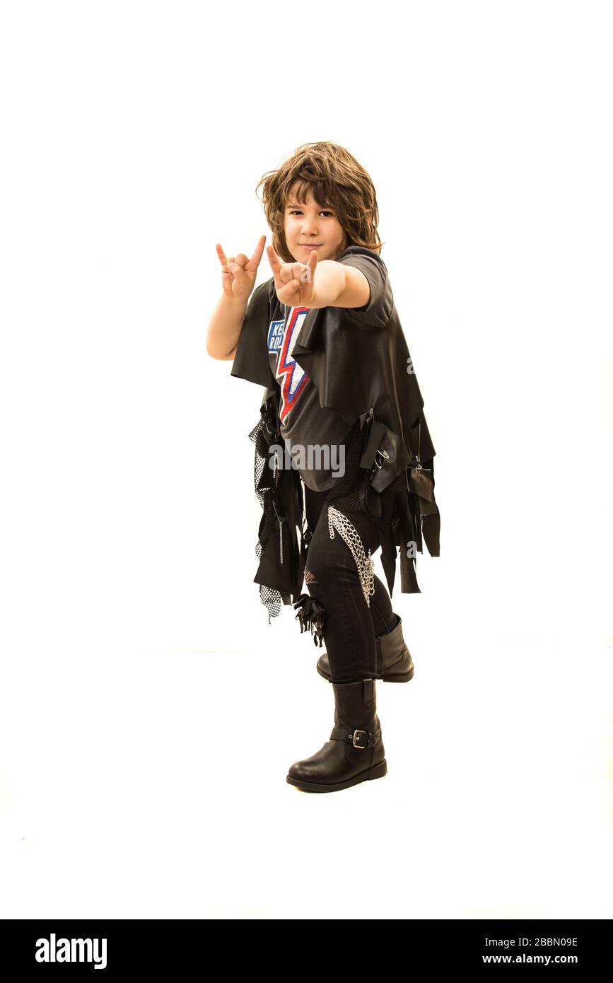 Full length of rocker boy showing rock sign fingers isolated on white ...