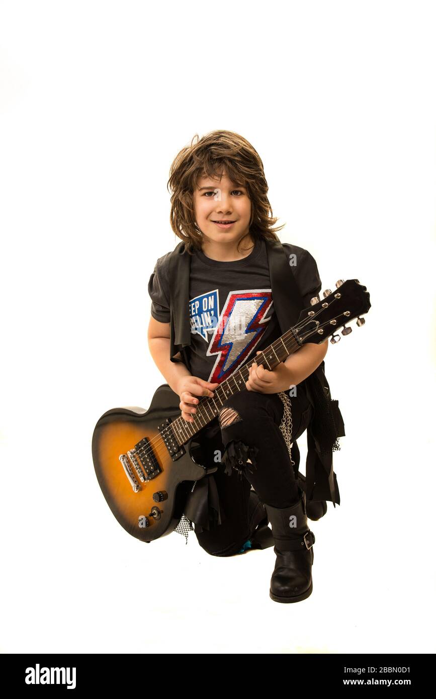 Adorable seven years old boy rocker with quitar isolated on white ...