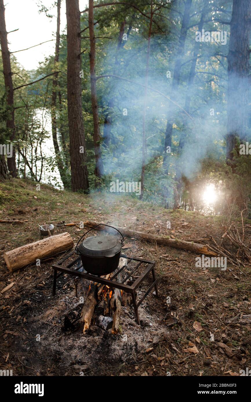 Forest cooking on campfire in the morning. Breakfast cooking in the ...