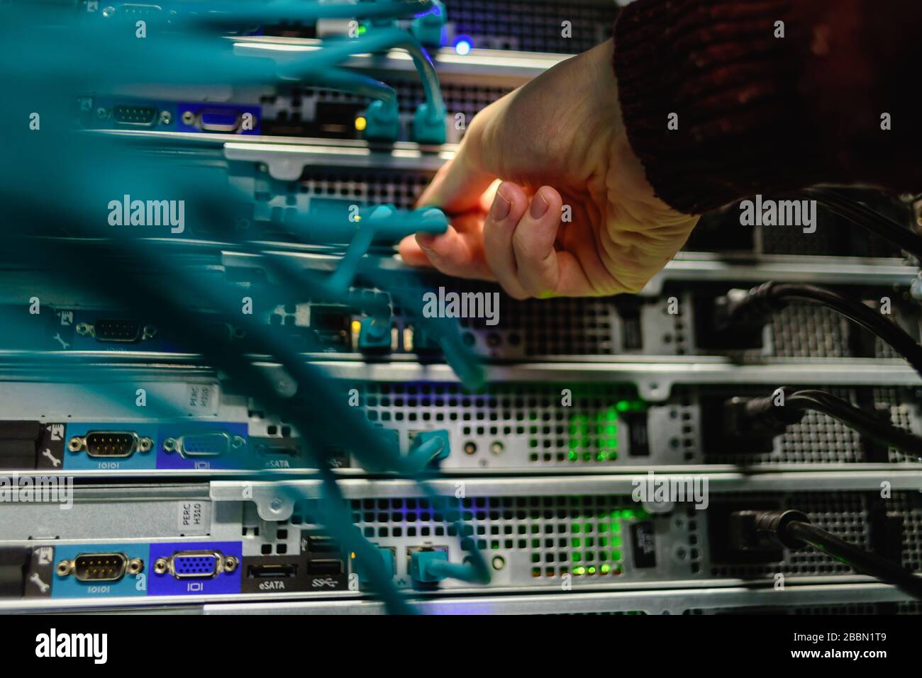 Man data center technician performing server maintenance. Replacing ...