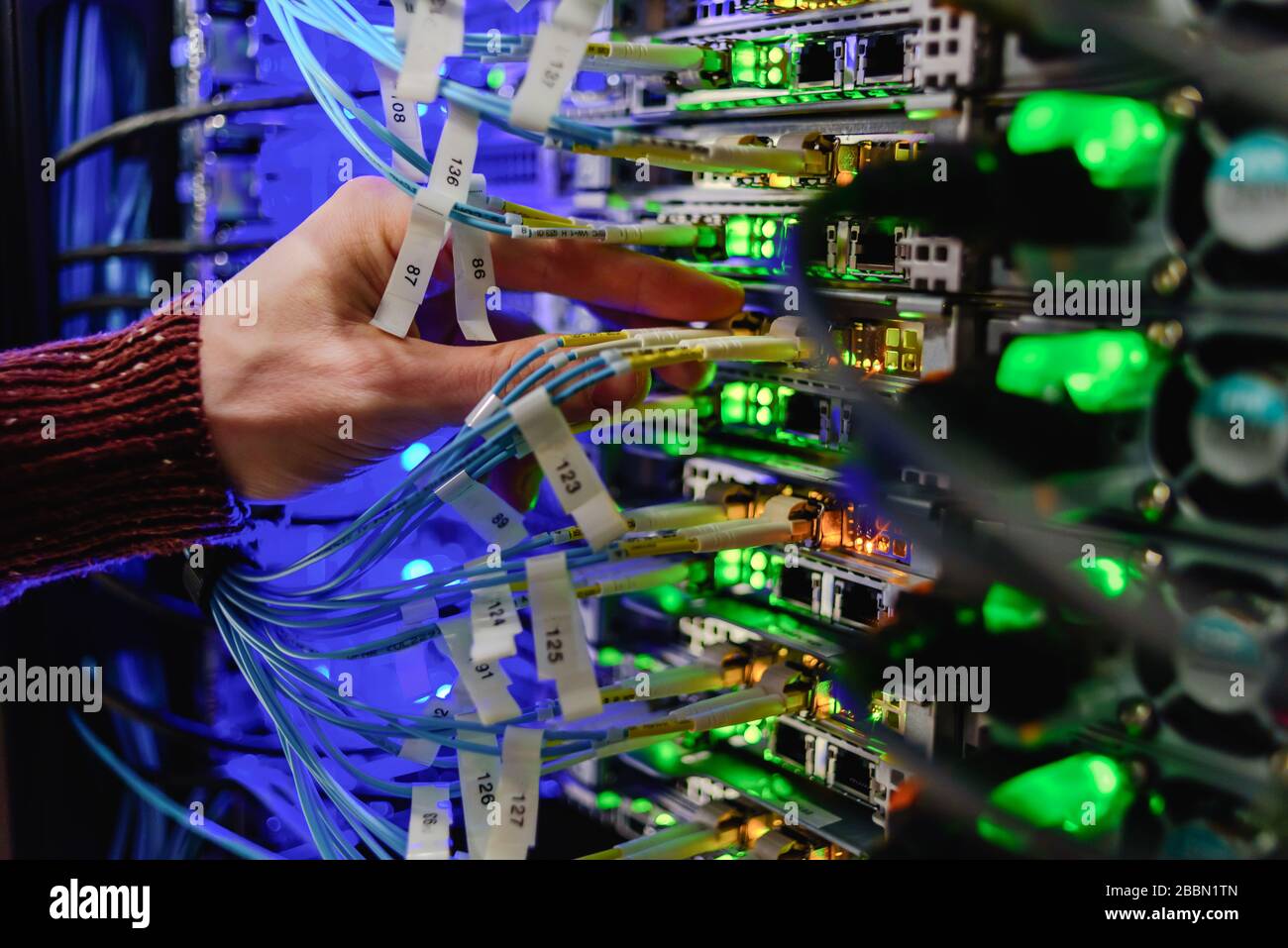 Man data center technician performing server maintenance. Replacing ...