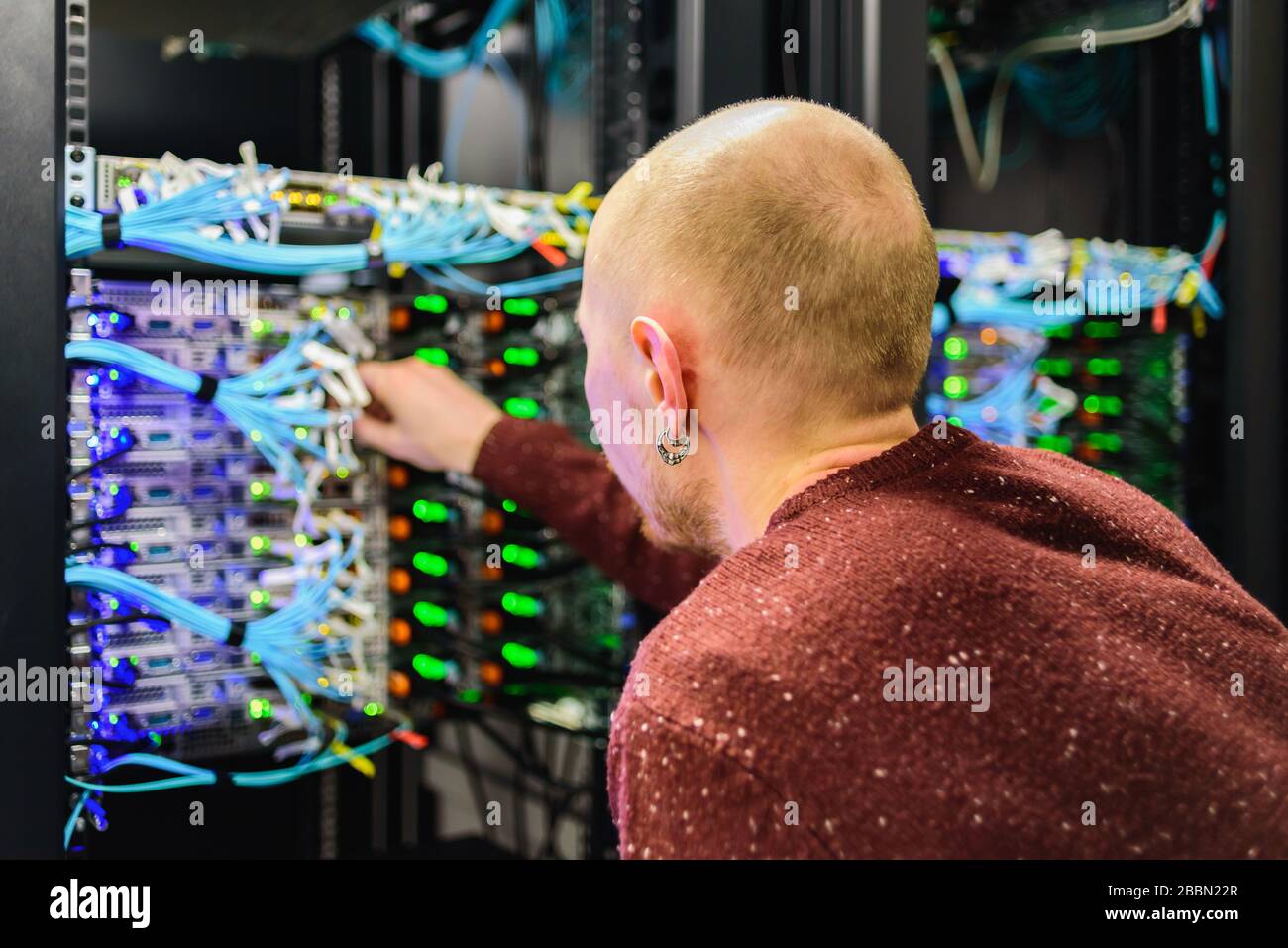 Man data center technician performing server maintenance. Replacing ...