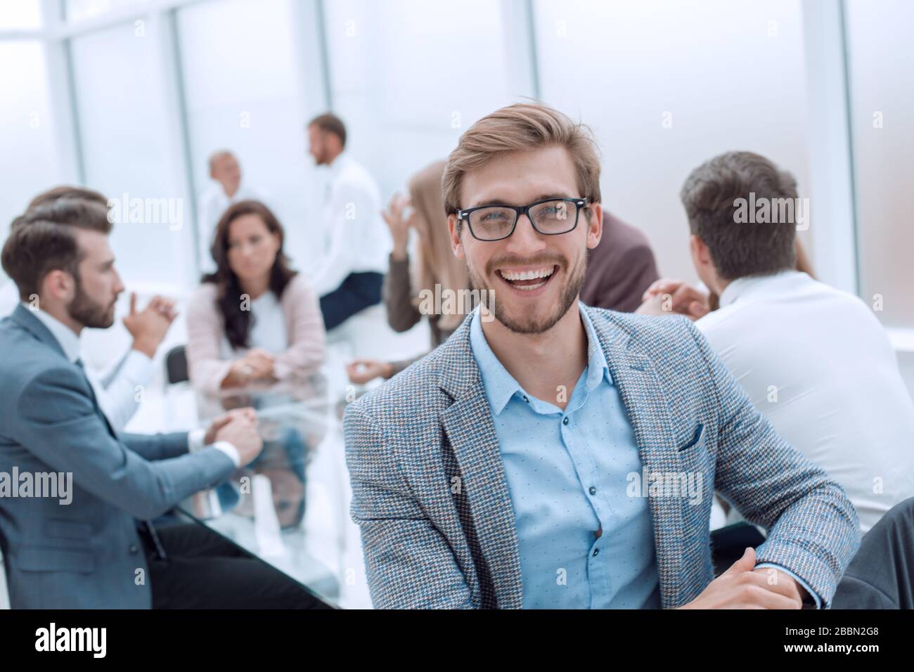 successful business man on the background of the office Stock Photo - Alamy