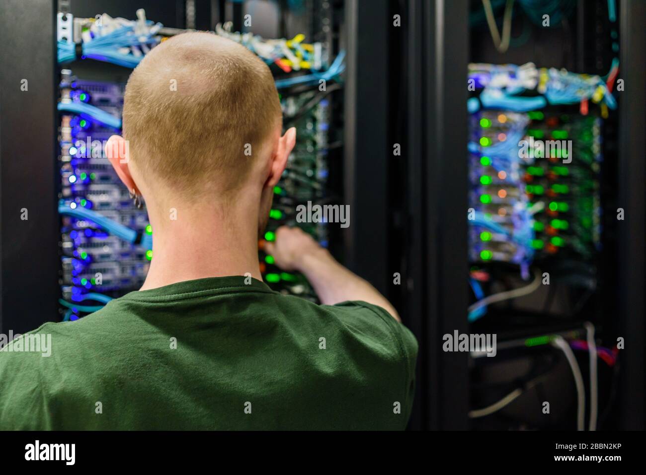 Man data center technician performing server maintenance. Replacing ...