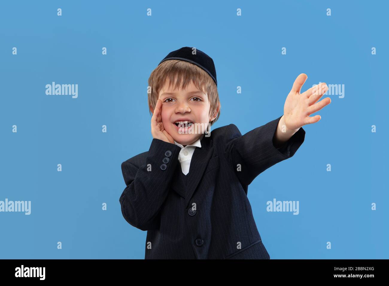 Calling, shouting. Portrait of a young orthodox jewish boy isolated on ...