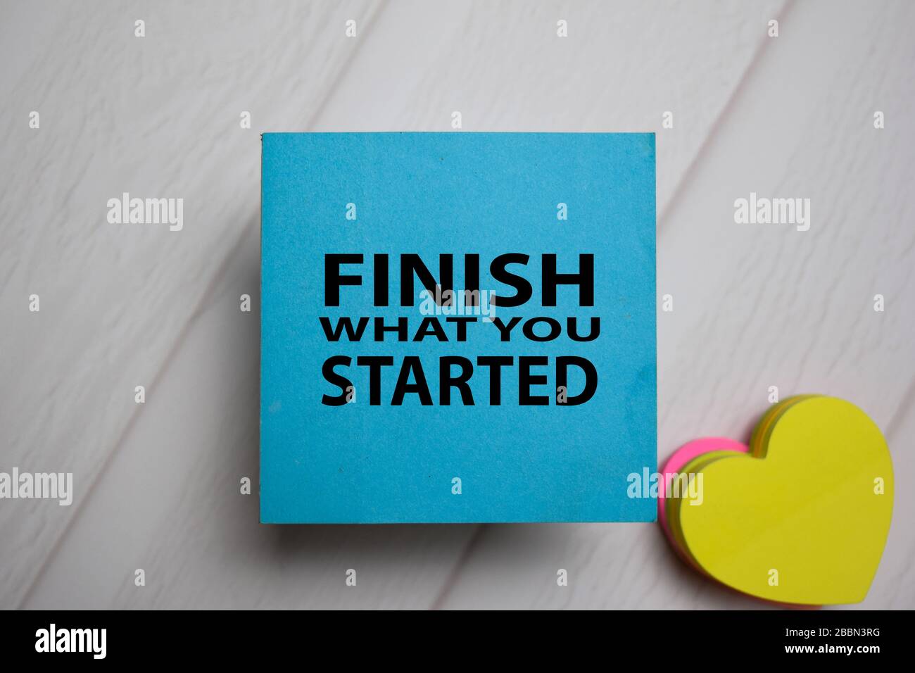 Finish What You Started write on a sticky note isolated on Office Desk ...