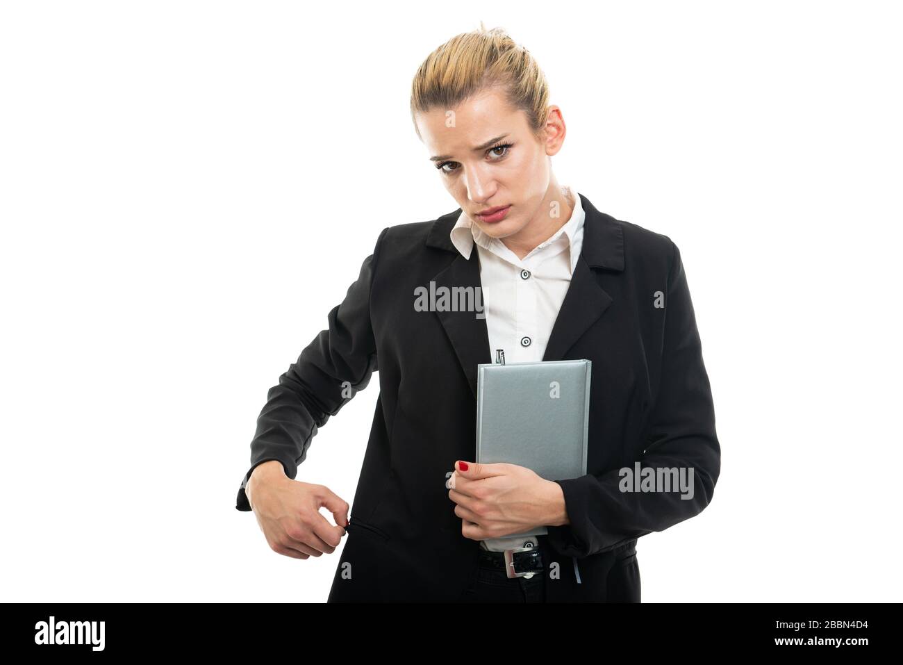 Young female assistant manager holding agenda making confused gesture ...