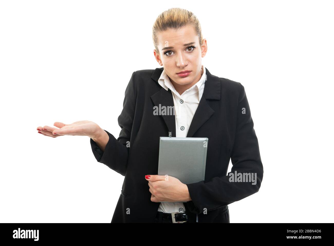 Young female assistant manager holding agenda making confused gesture ...