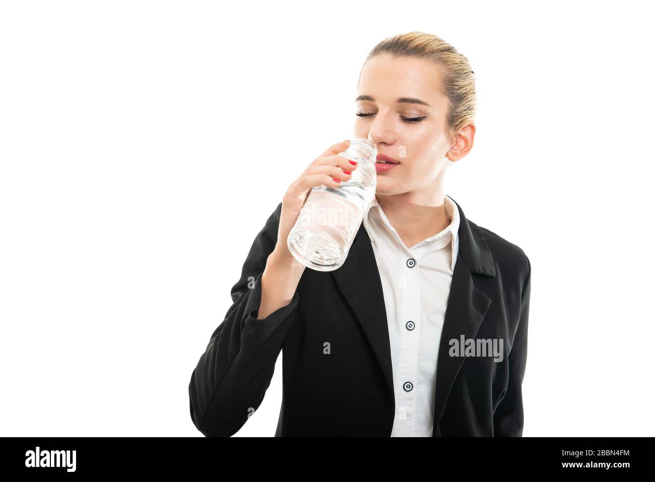 Portrait of beautiful young female assistant manager drinking water ...