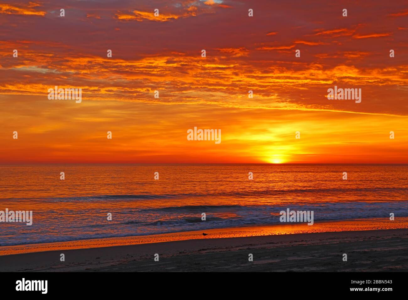 Dramatic clouds mask the sun as it rises over the Atlantic ocean to ...