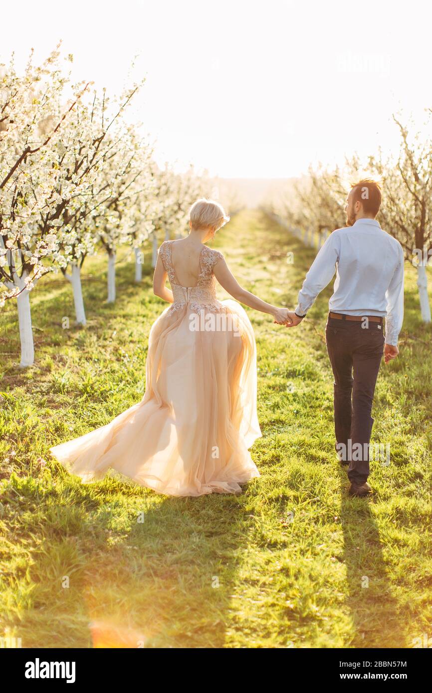 Back full length view of romantic couple man and woman in spring ...