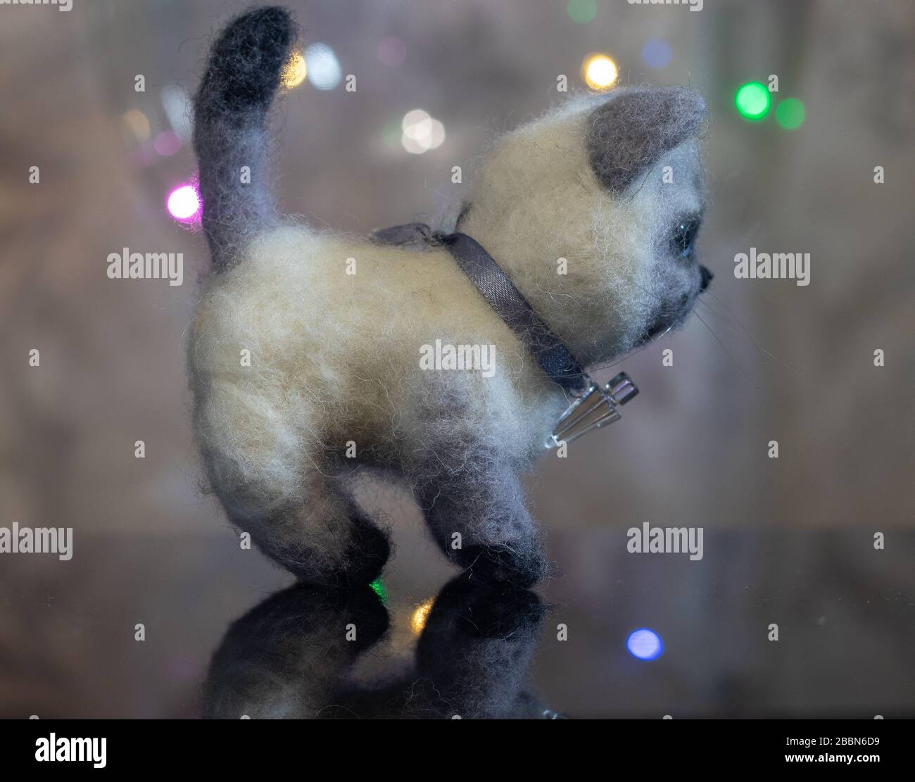 Toy cat, side view, on a background lit by lights Stock Photo - Alamy