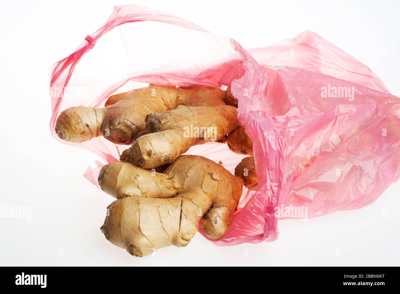 Studio shot of ginger in a plastic bag isolated on white background ...