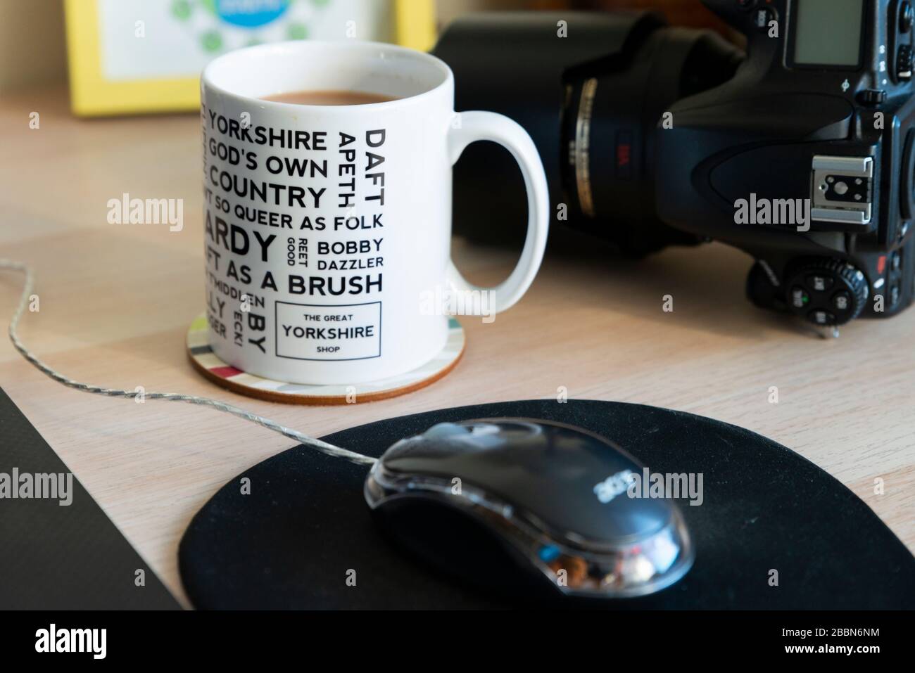 A mug of tea on a desk set up for working from home Stock Photo - Alamy