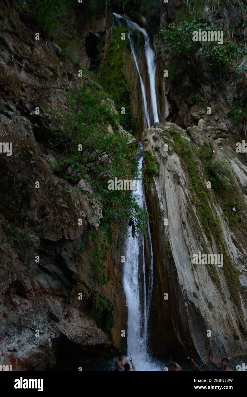 Group of people enjoying under the famous neer garh Waterfall ...