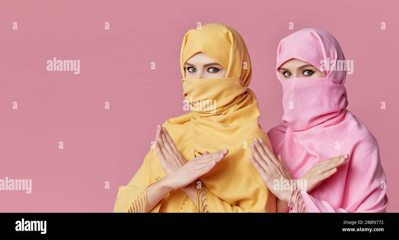 Girl power. Two young Muslim arabian women wearing colorful hijabs ...