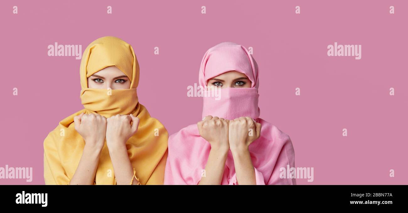 Girl power. Two young Muslim arabian women wearing colorful hijabs ...