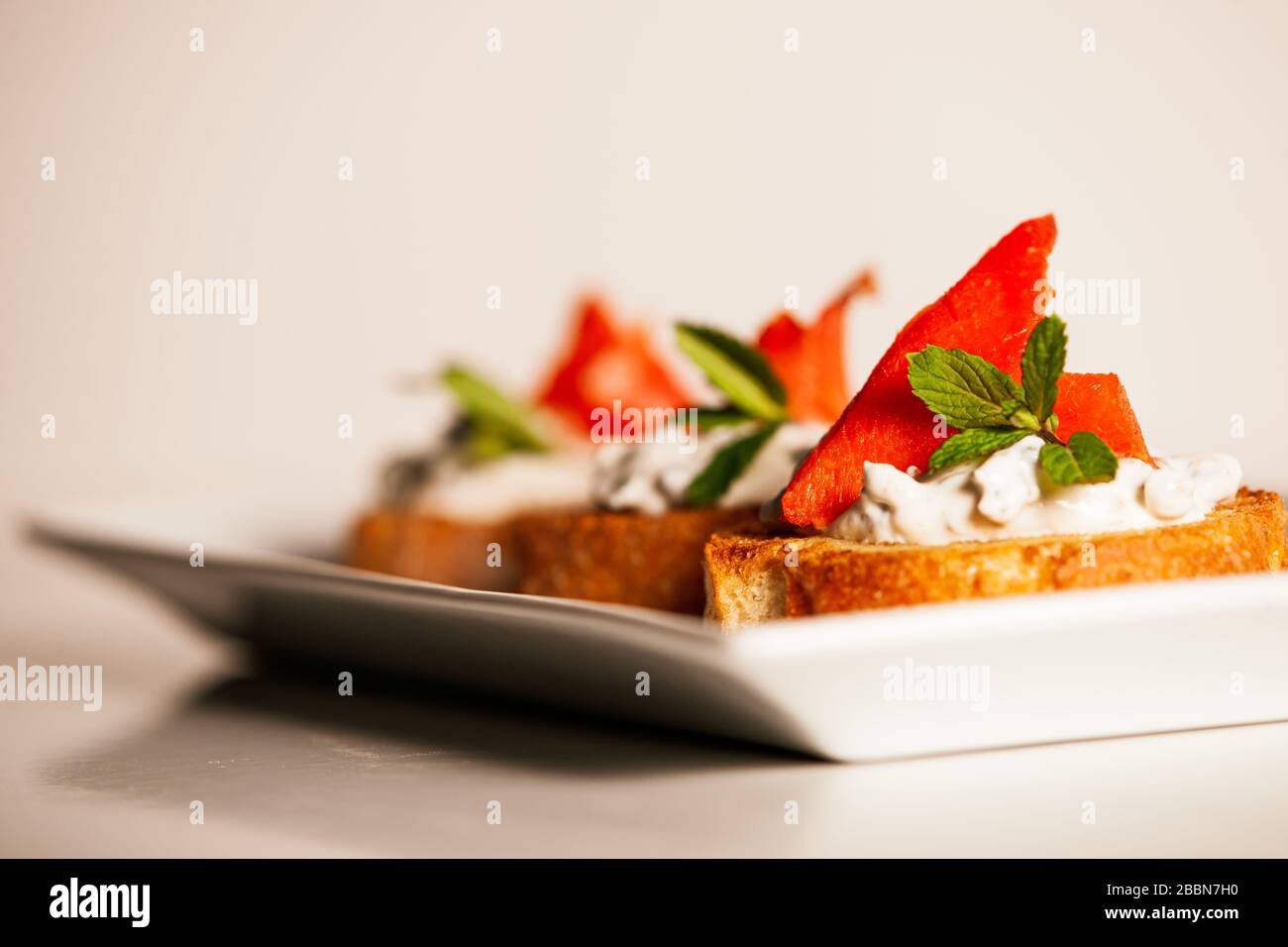 Plate of decorative fish bruschetta appetizer Stock Photo - Alamy