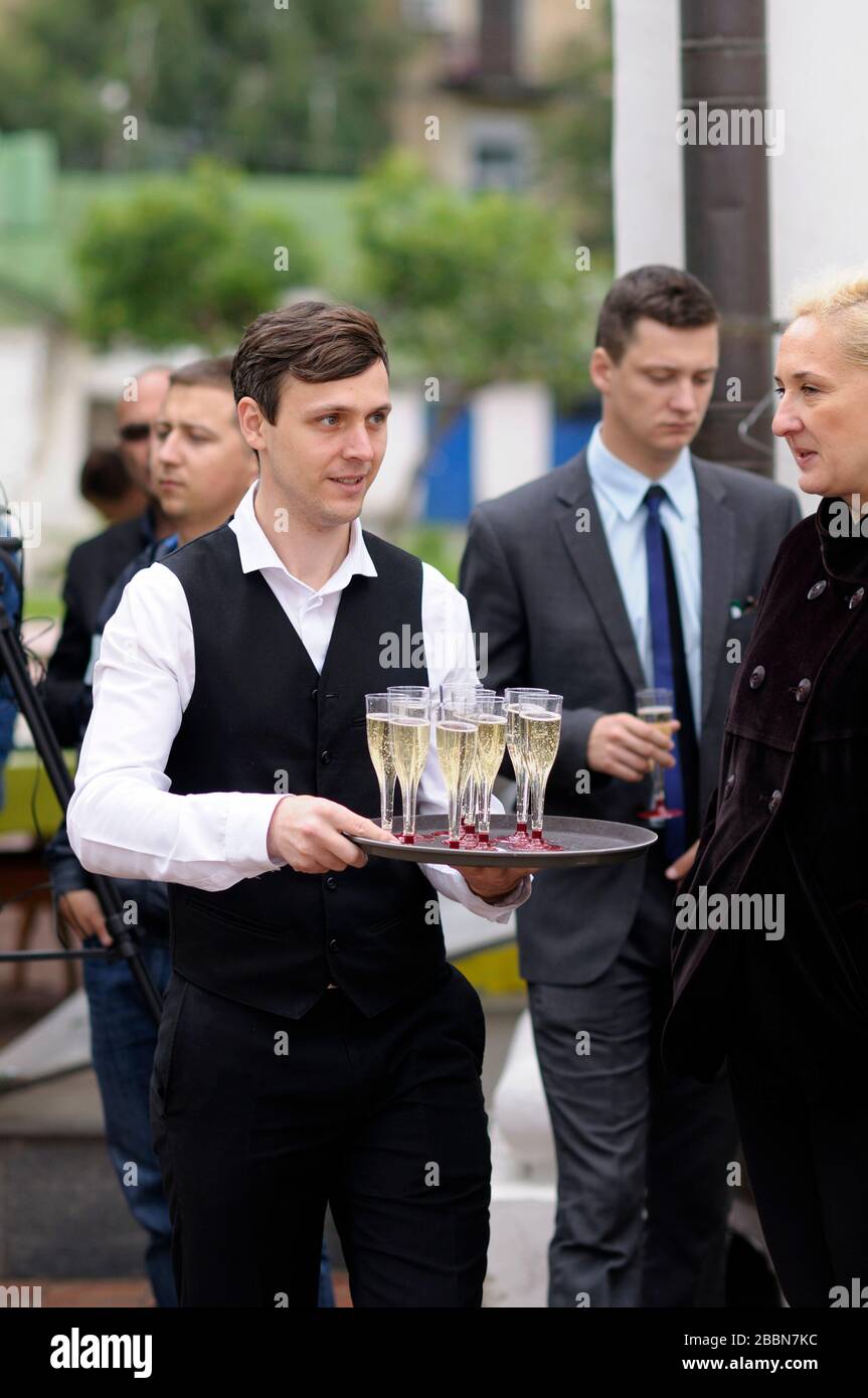 Waiter carrying tray hi-res stock photography and images - Alamy