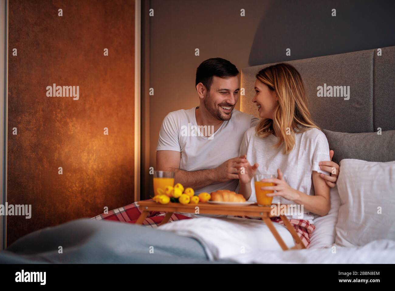 Happy couple having a breakfast in the bed.Romantic moments at home ...