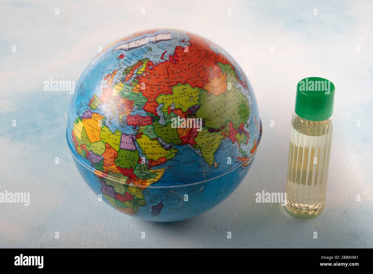 cologne for the world. Globe and cologne ( kolonya ) isolated on blue ...