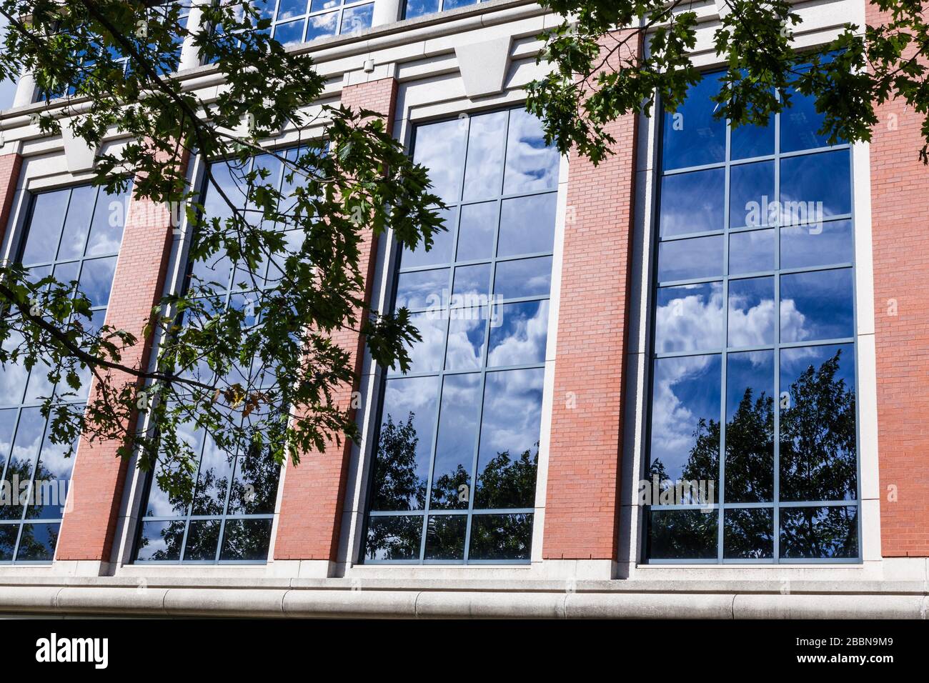 Sky and clouds reflection in windows of a building Stock Photo - Alamy