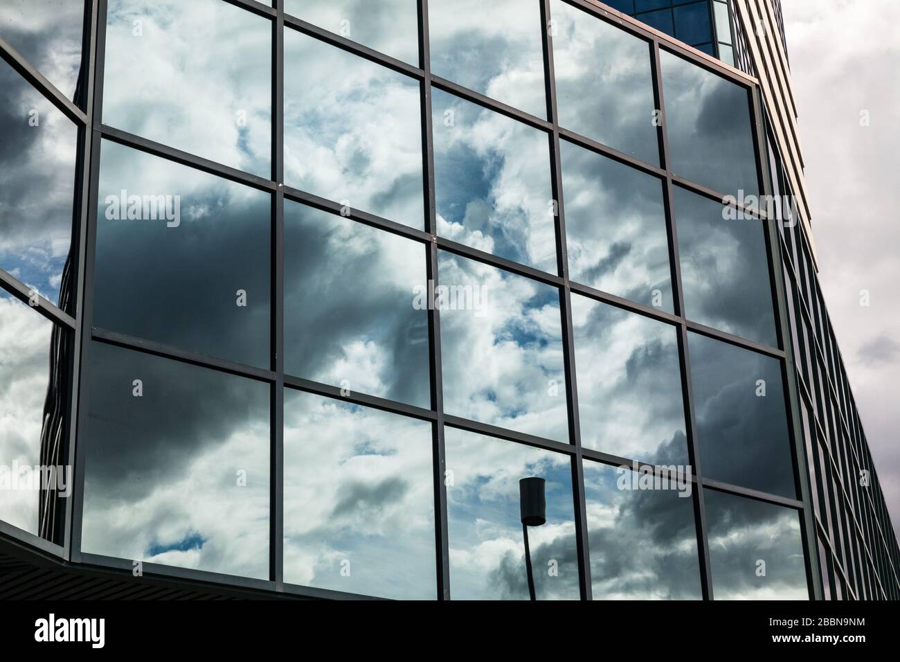 Sky and clouds reflection in windows of a building Stock Photo - Alamy