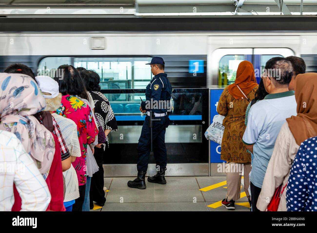 Indonesian People Queue To Board A Metro (MRT) Train, Jakarta ...