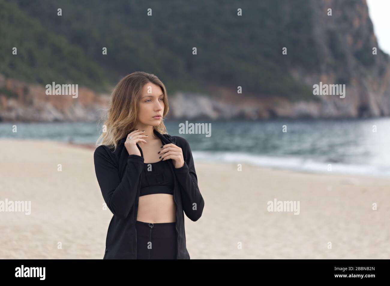 Horizontal portrait of fit and attractive female in black cropped top ...