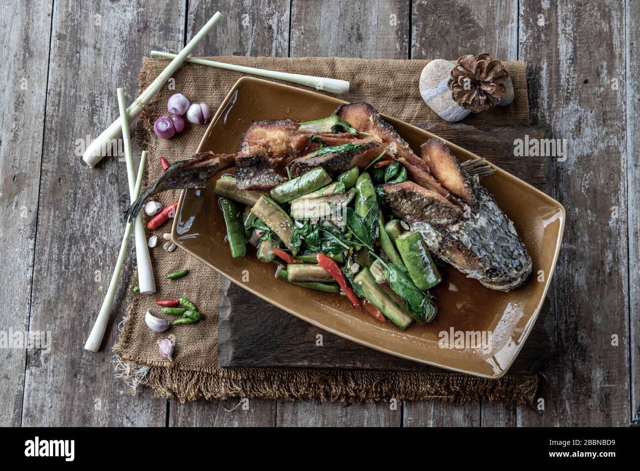 Deep fried whole Snakehead with Spicy stir fry eggplant, Thai food for ...