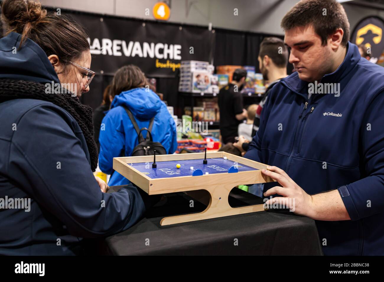 A couple playing at “Klask” at the game and toy fair of Quebec City ...
